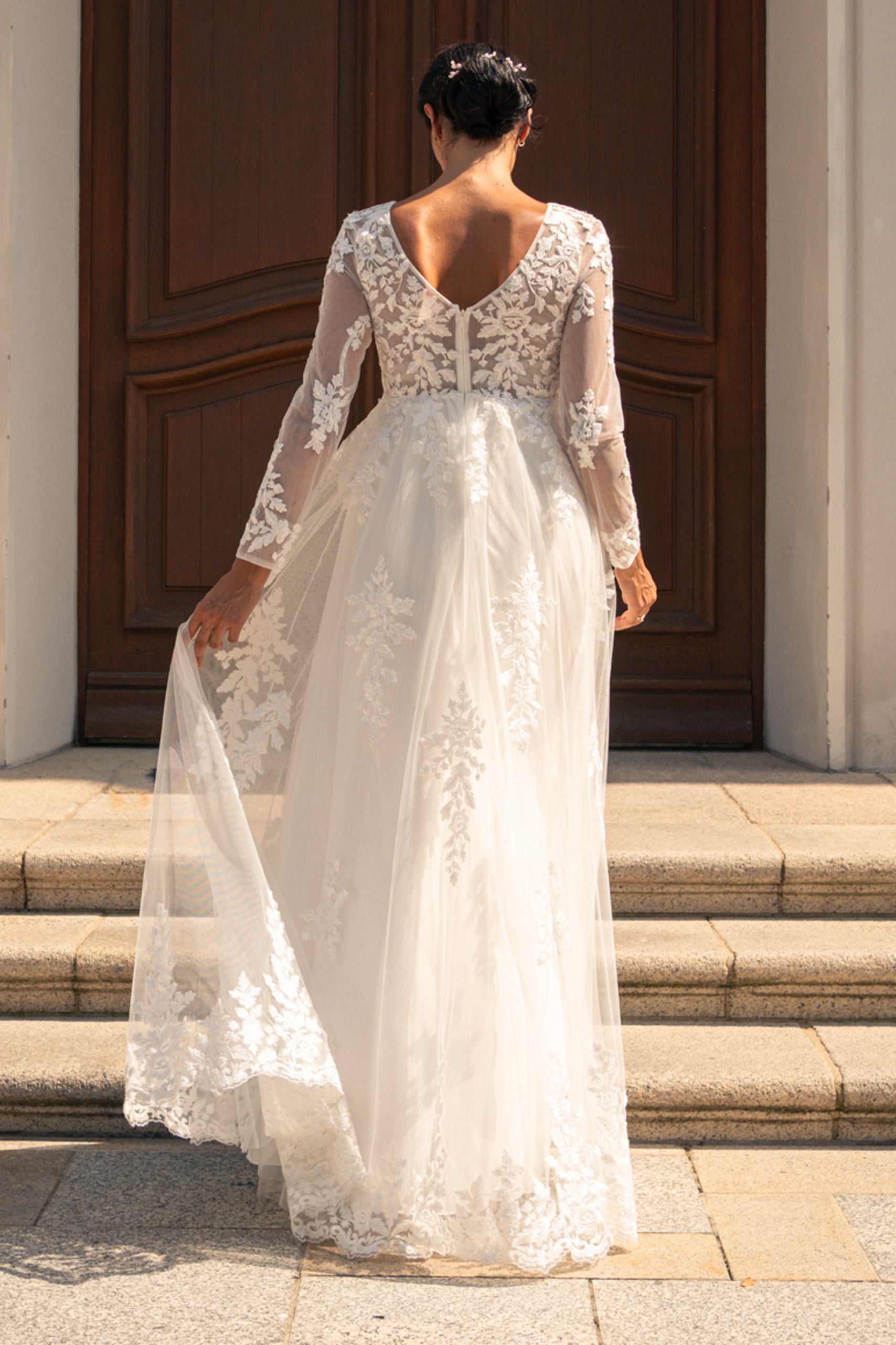 Maternity bridal gown with sweetheart neckline and lace appliqués ...